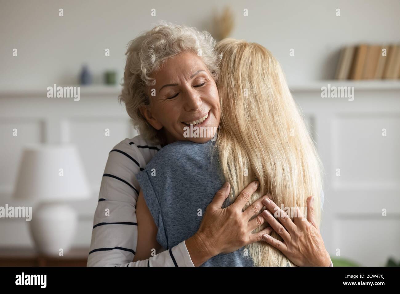 Happy retired mom enjoying cuddles of beloved grownup daughter Stock ...