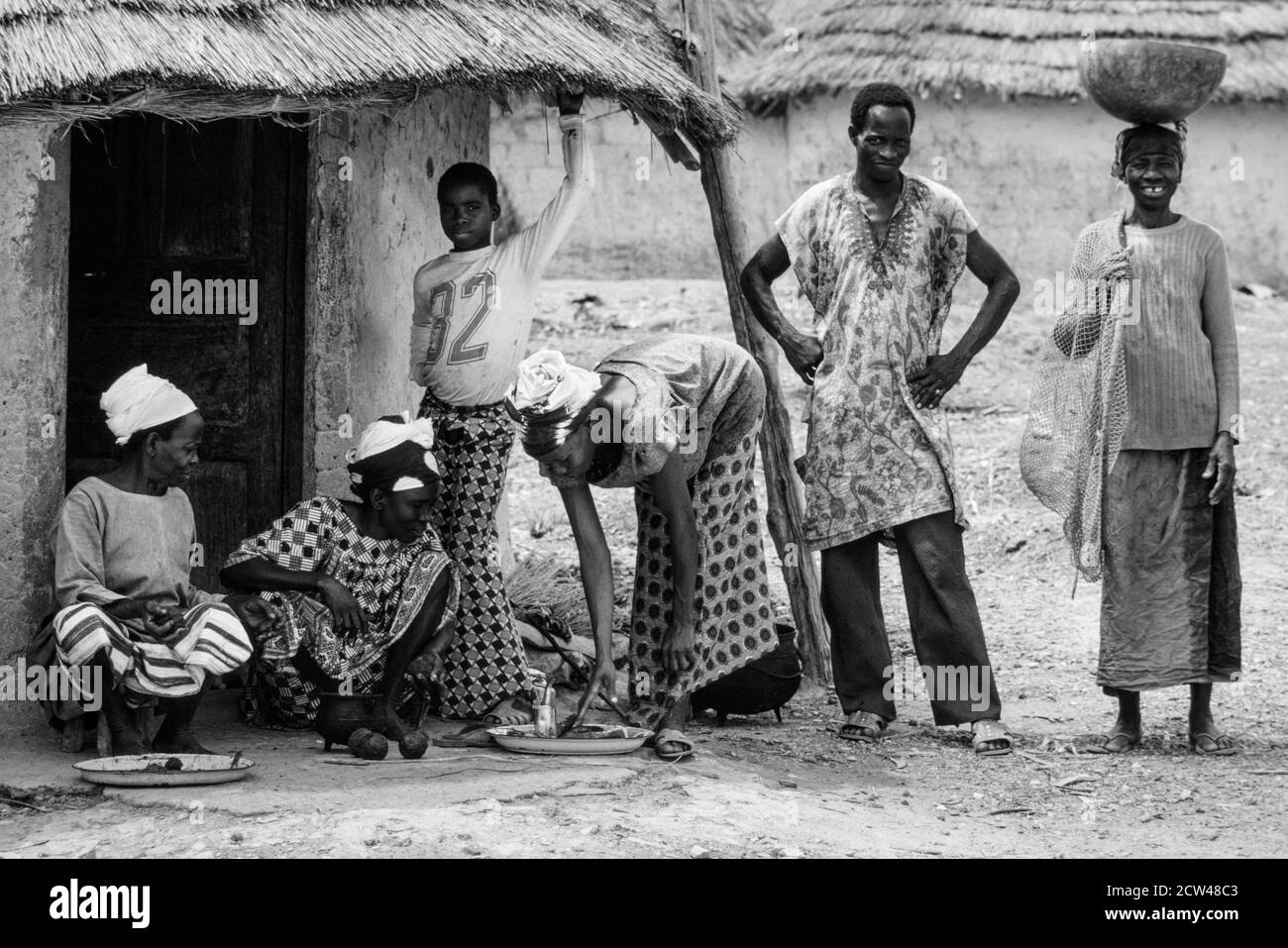 Family outside their traditional house in a village Guinea West Africa ...