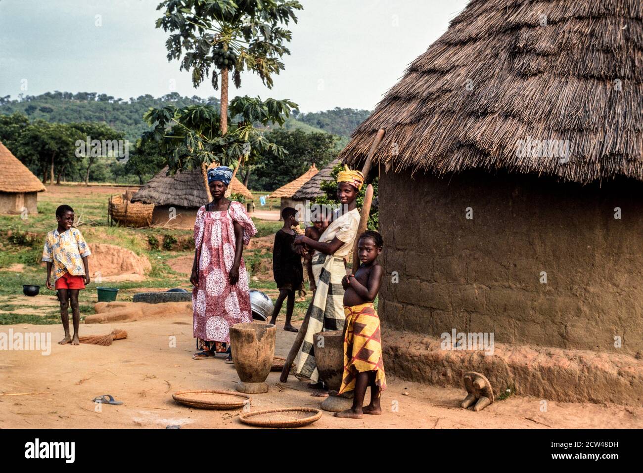 Family outside their traditional house in a village Guinea West Africa ...