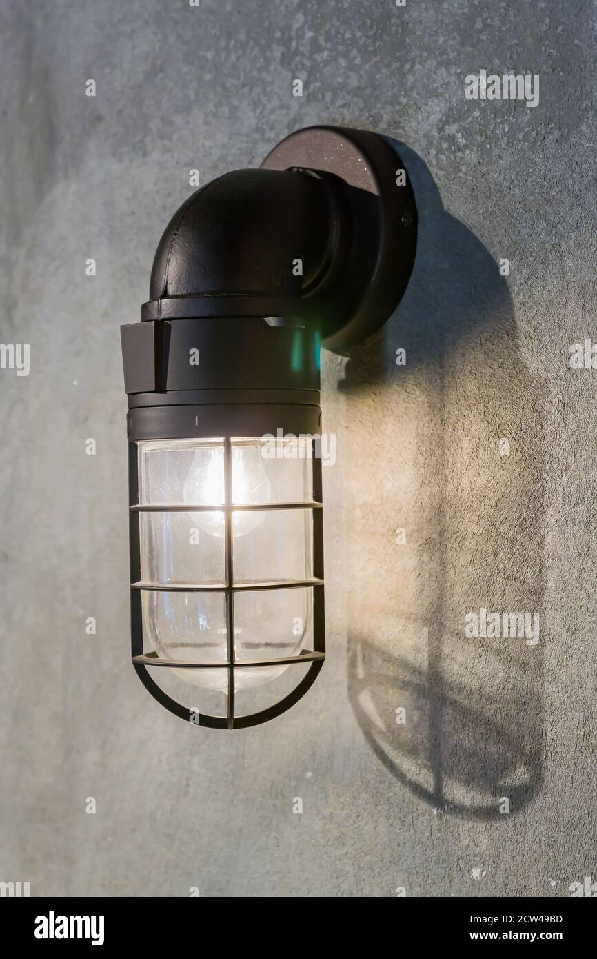 industrial style lantern on concrete wall Stock Photo - Alamy