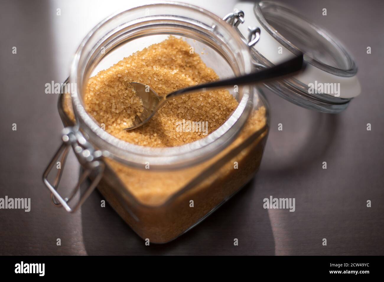Transparent glass jar with brown sugar cane on a black background Stock ...