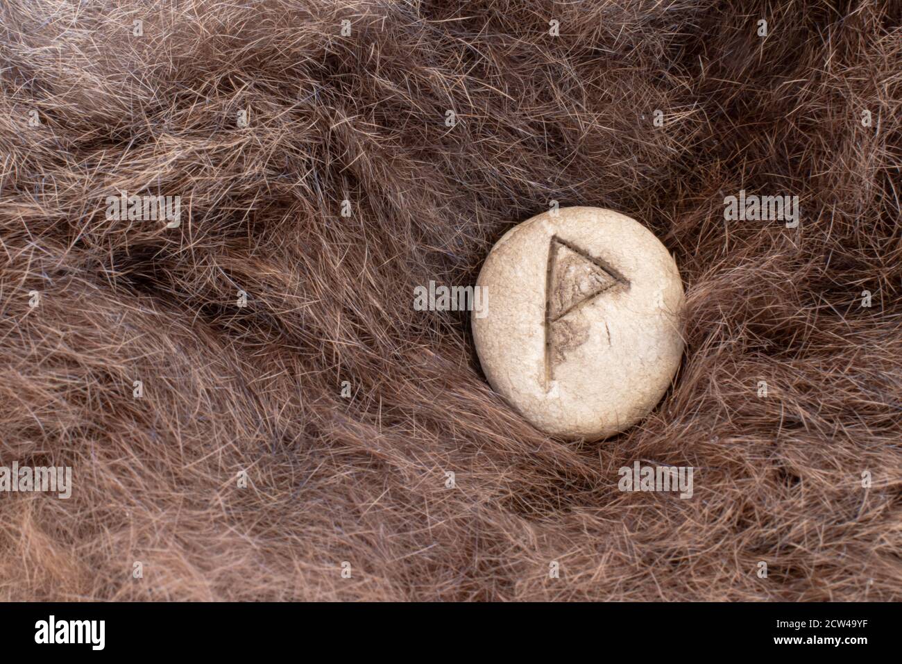 Wunjo Nordic stone rune on fur. Letter Wyn of the Viking alphabet Stock ...