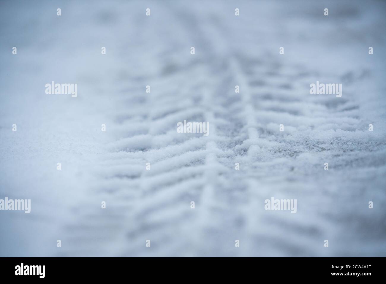 Snow covered road with tire tracks Stock Photo - Alamy