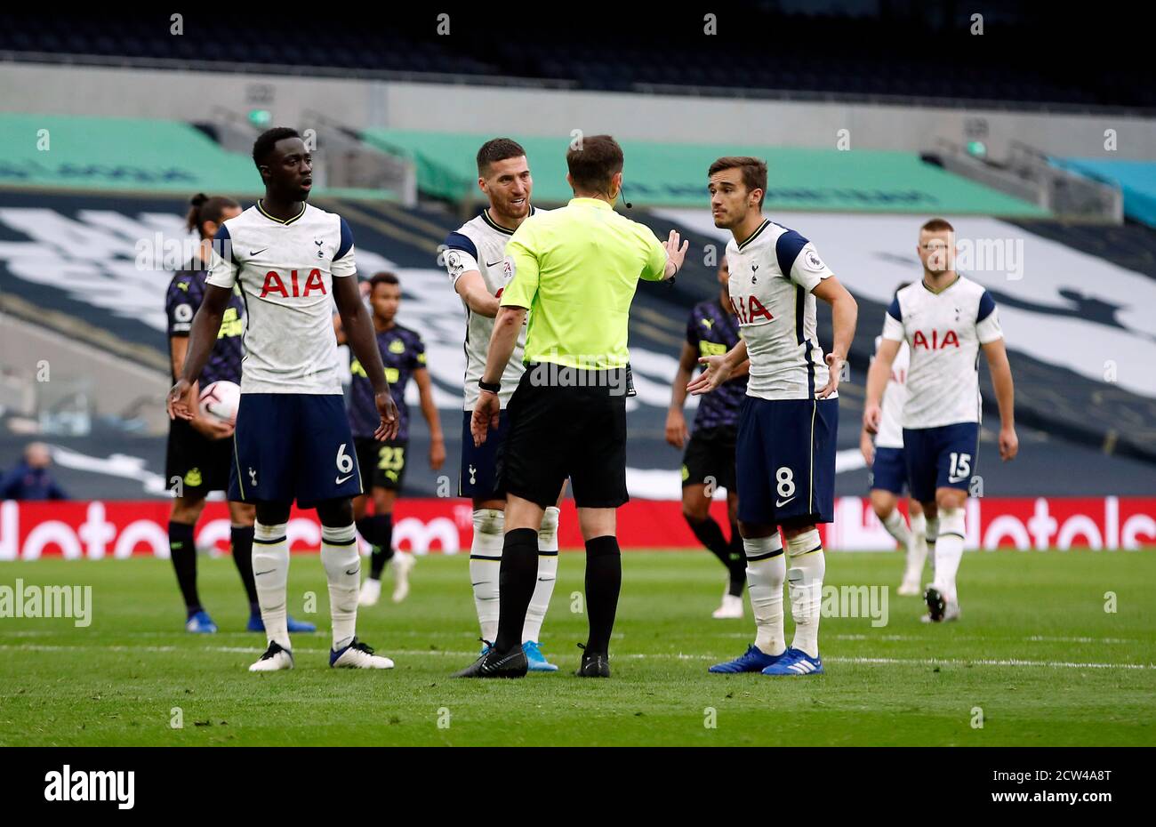 Tottenham Hotspur players surround referee Peter Bankes after he awards ...