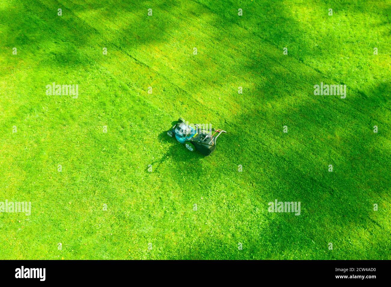 Aerial mowing lawns. Top aerial view lawn mower on green grass. Mower ...