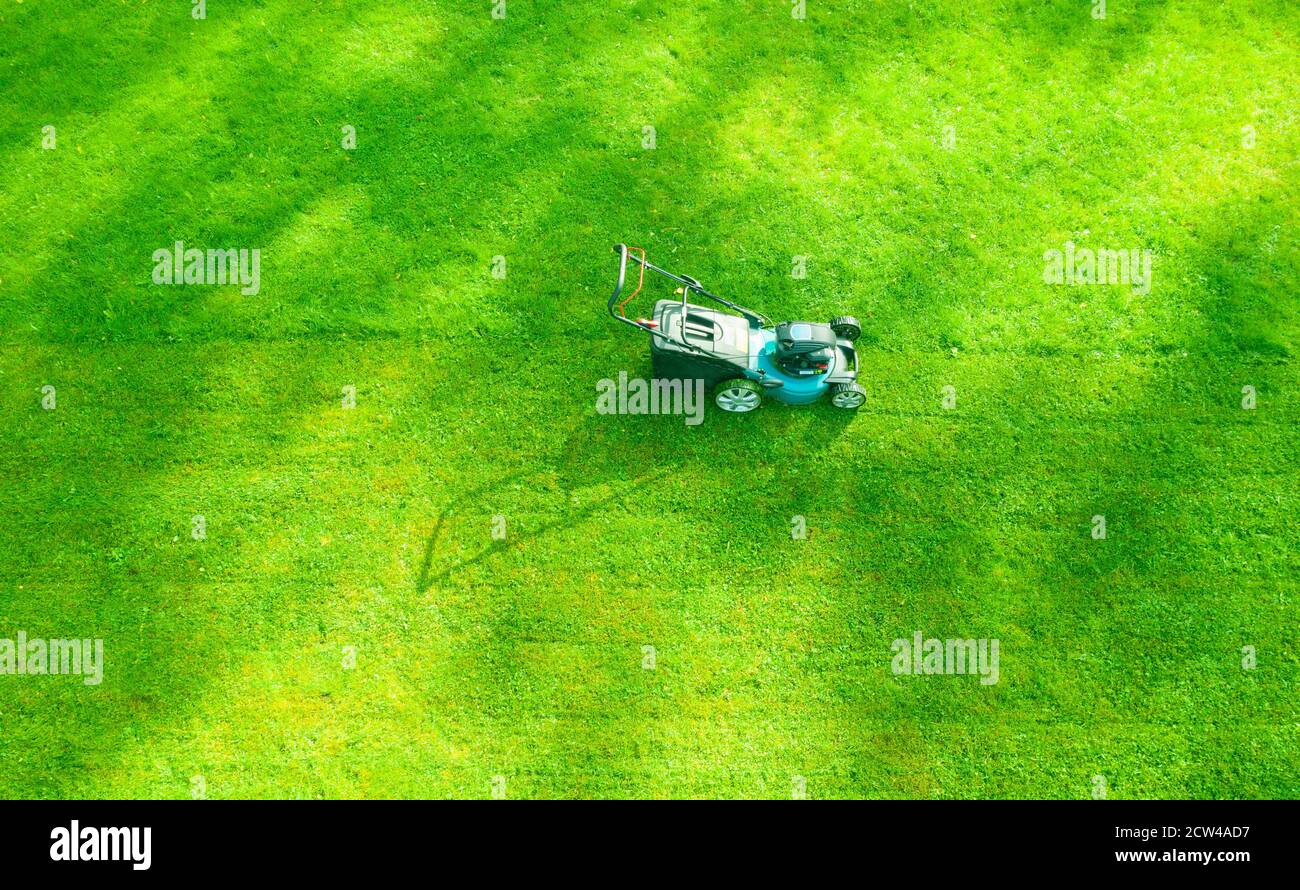 Aerial mowing lawns. Top aerial view lawn mower on green grass. Mower ...