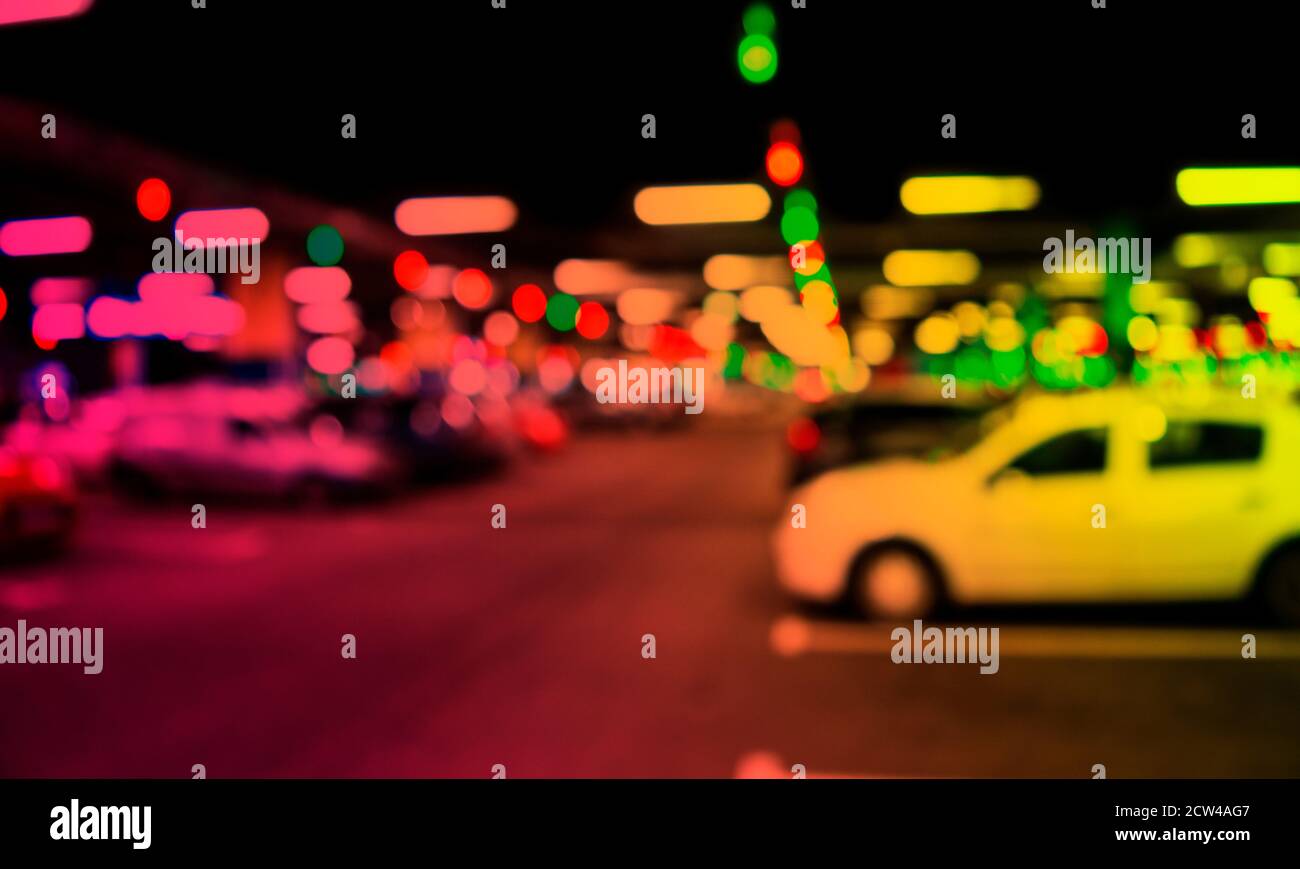 Blurred cars in car parking lot in shopping mall. Bokeh lights ...