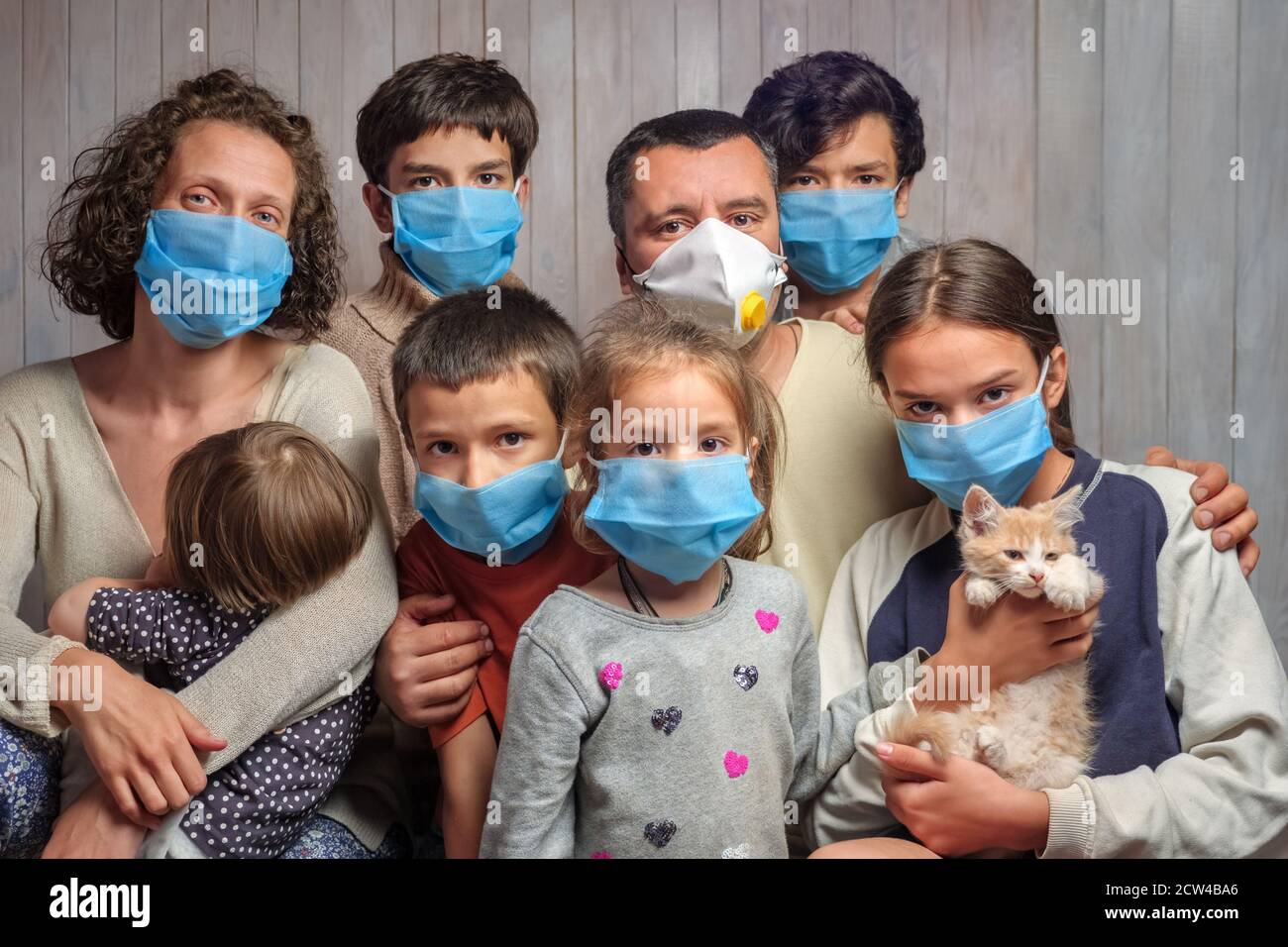 Big family in protection masks looking at the camera. Prevention ...