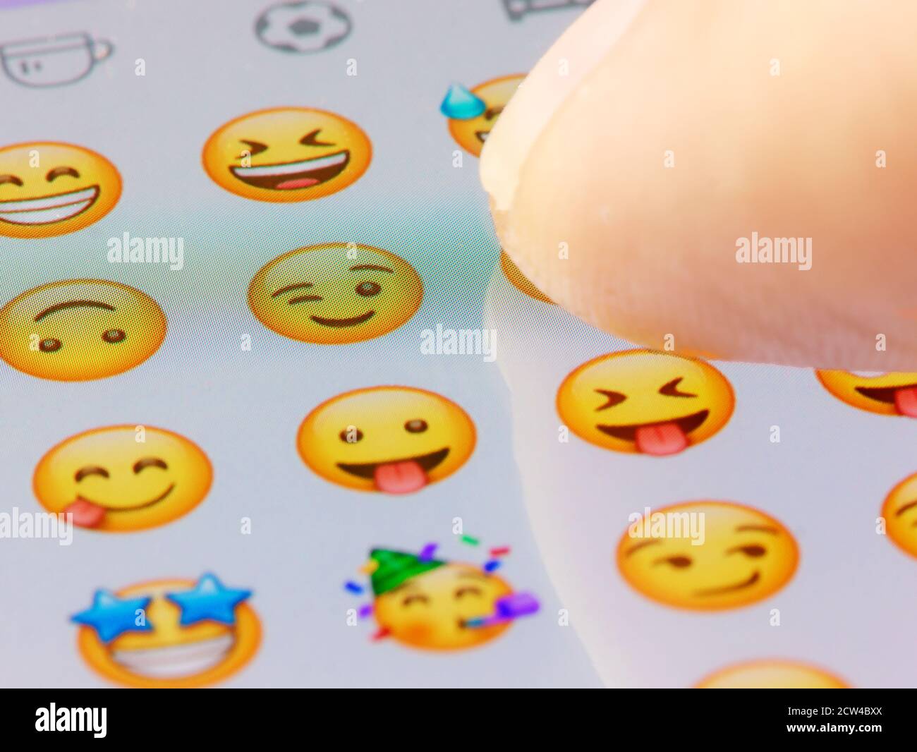 Closeup finger taping icon on screen keyboard Stock Photo - Alamy