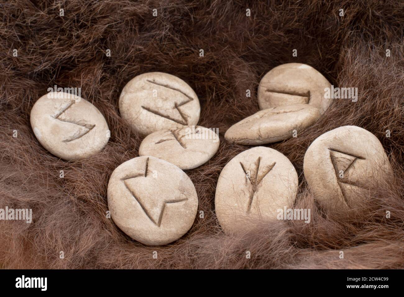 Stone runes on a fur. Futhark viking alphabet. Close up photo of Norse ...
