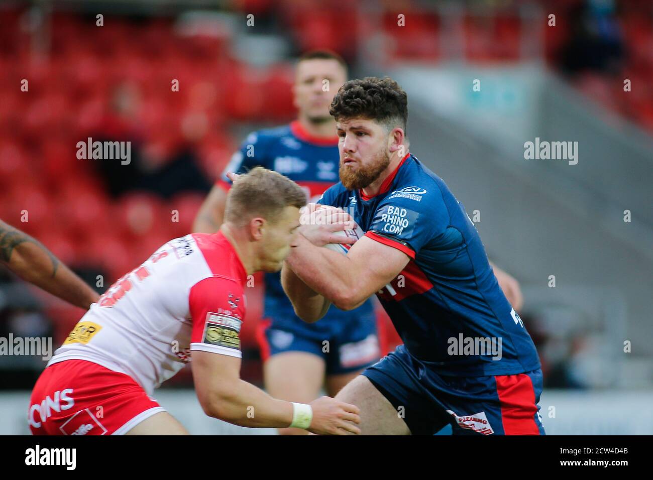 Mitch Garbutt (14) of Hull KR tackled by Matthew Lees (15) of St Helens ...