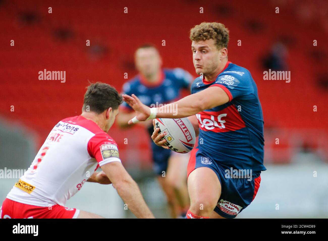 George Lawler (15) of Hull KR hands off Lachlan Coote (1) of St Helens ...