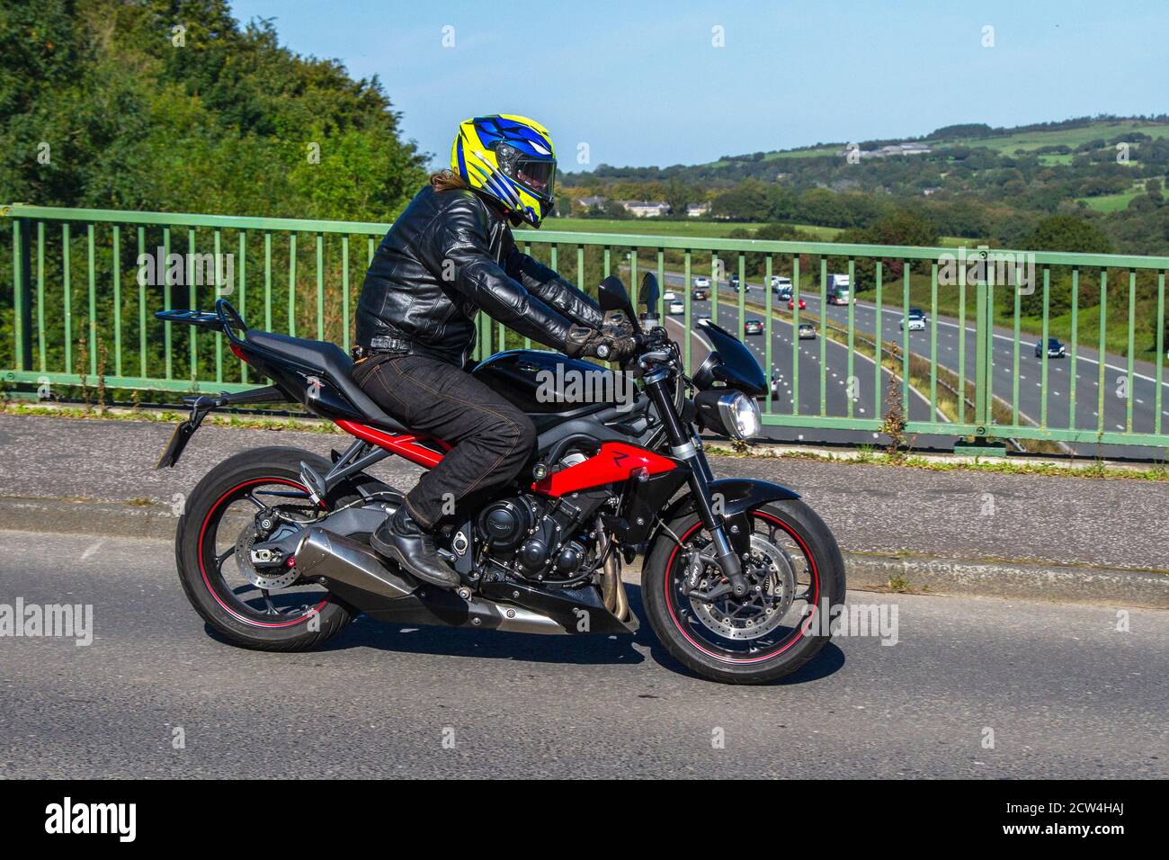 2014 red Triumph Street Triple Motorbike rider; two wheeled transport ...