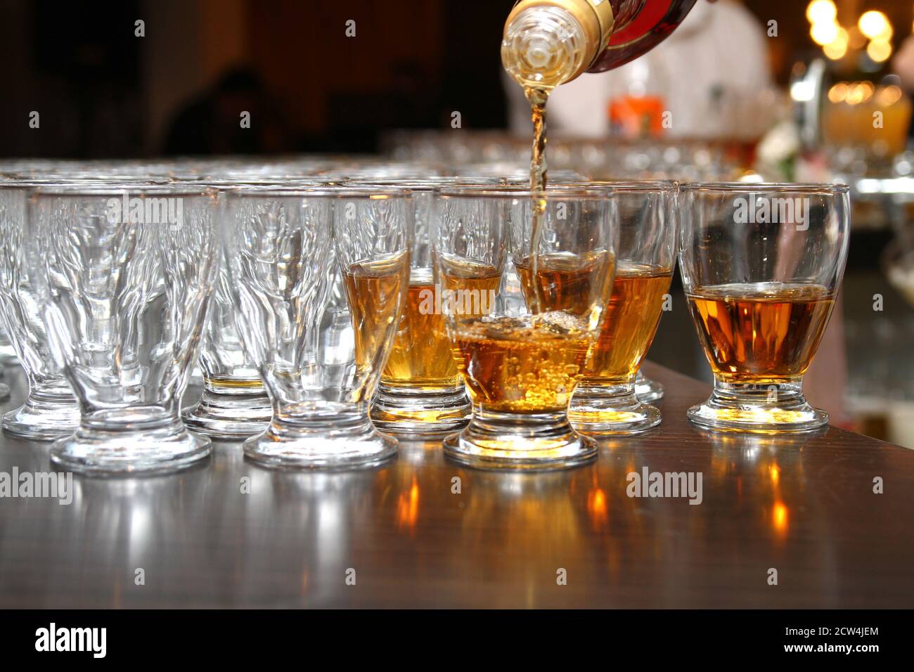 Pour into a glass for tasting brandy Stock Photo - Alamy