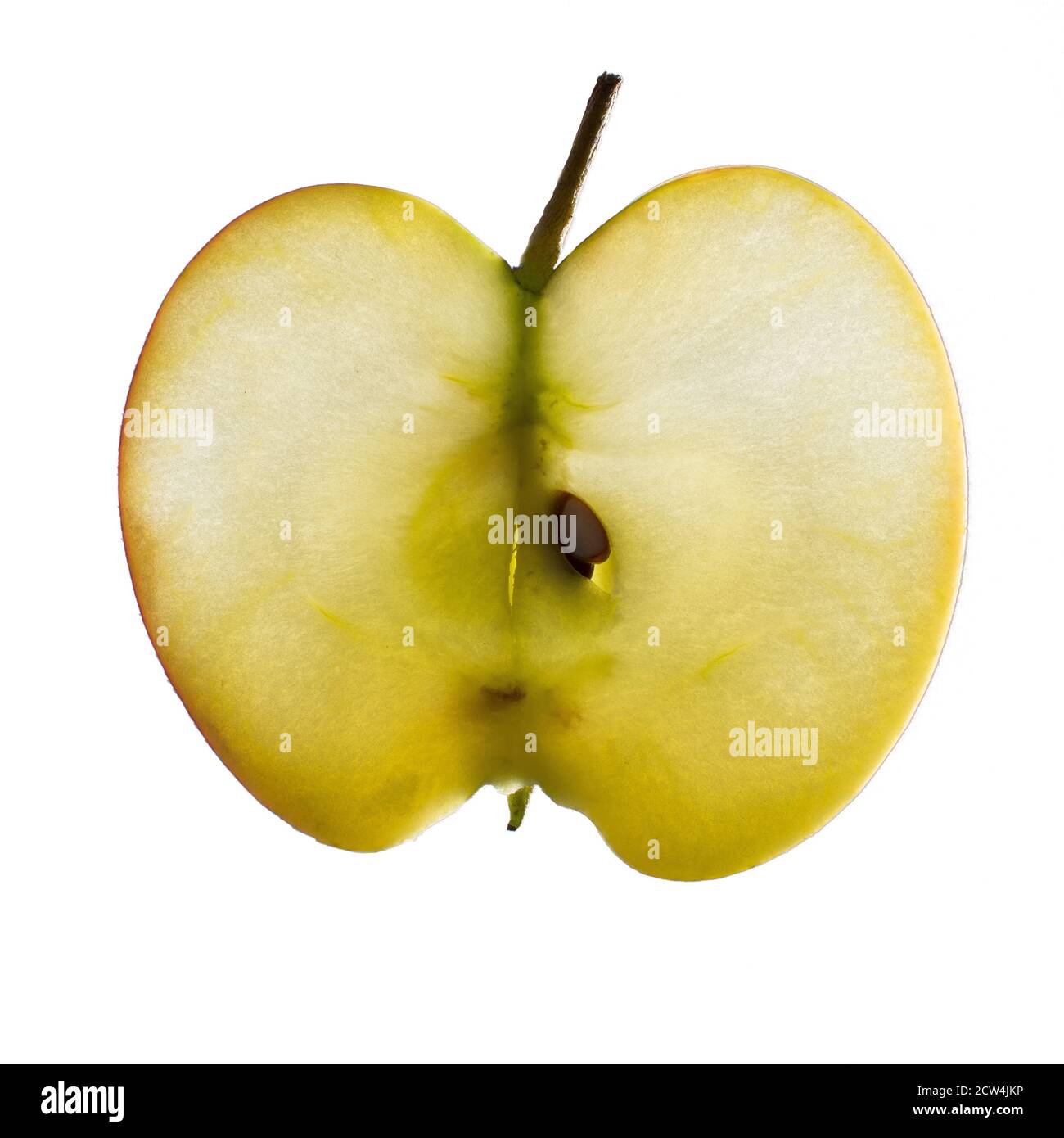 Slice of apple fruit with light shining through backlight showing the ...