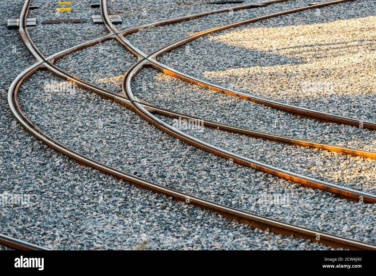 Curved tram rails and a crossing Stock Photo - Alamy