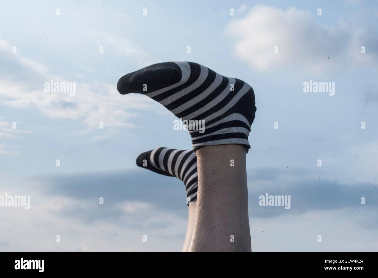 socks on human feet, person without shoes on their feet Stock Photo - Alamy