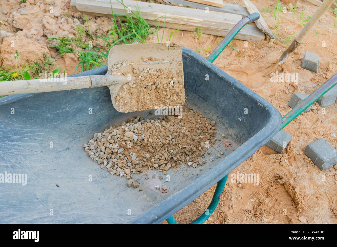 laying red and gray concrete paving blocks. Road Paving, construction ...