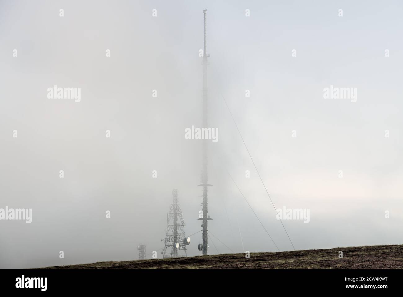 Transmitter tower at Three Rock Mountain covered into the clouds, Co ...