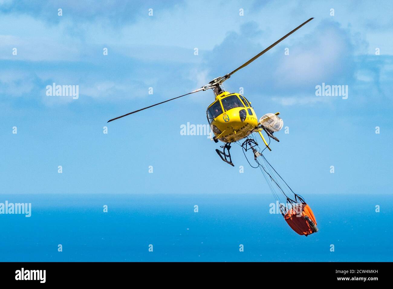 Helicopetor carrying water in firefighting tasks Stock Photo - Alamy