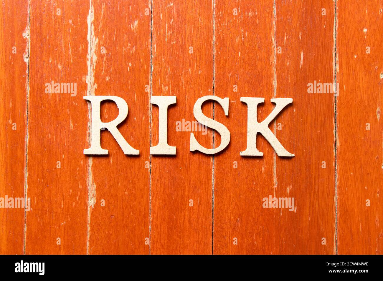 Alphabet letter in word risk on old red color wood plate background ...