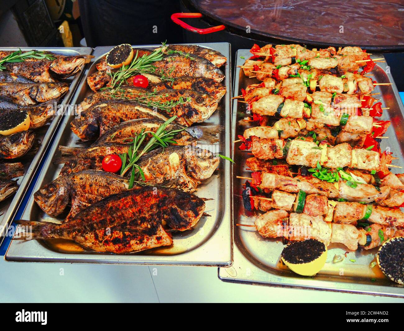 Grilled fish and grilled meat (shashlik) on market, tasty street food ...