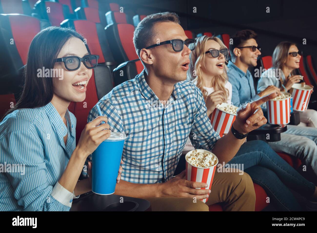 Young people friends together in the cinema Stock Photo - Alamy