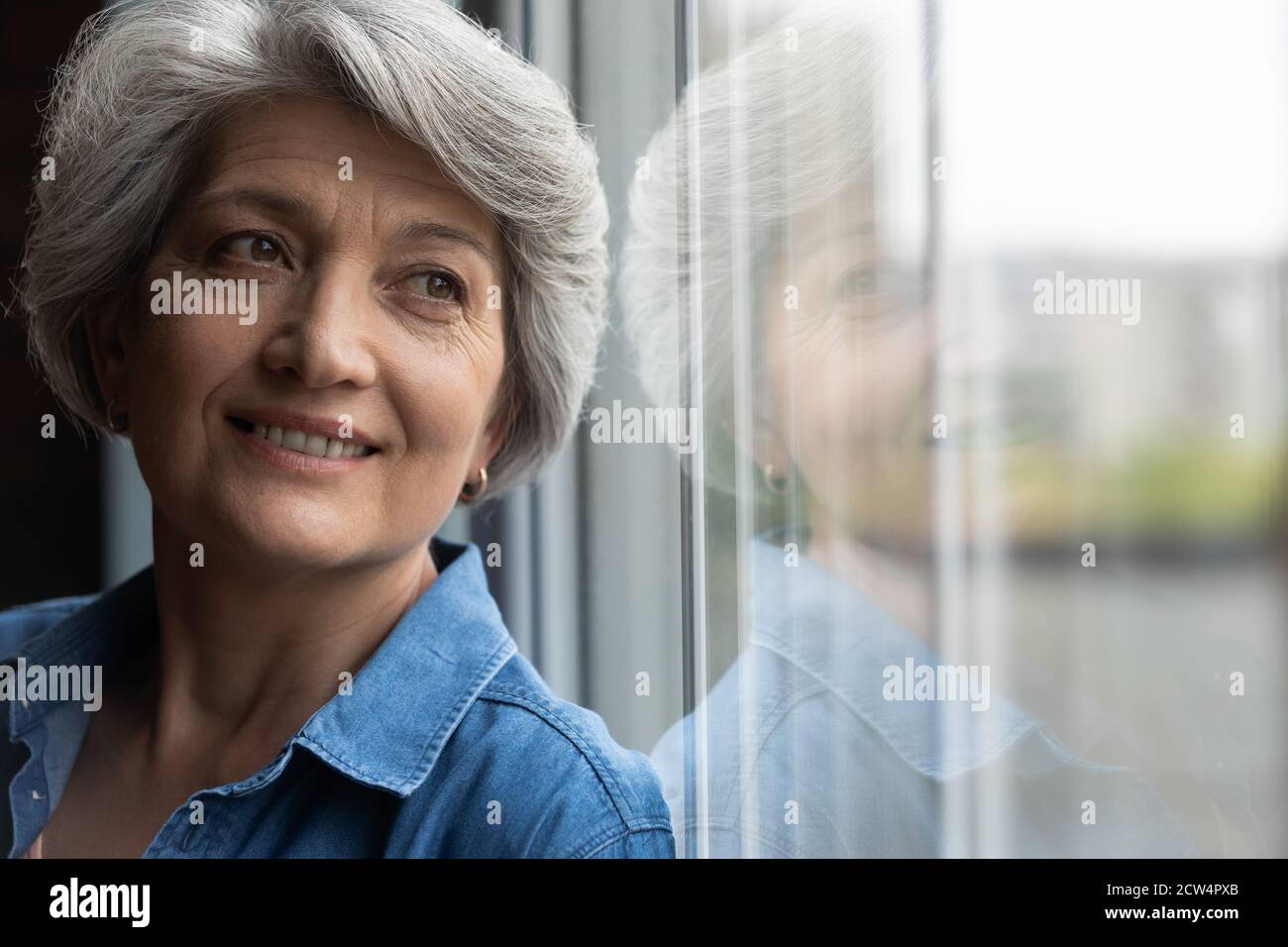 Dreamy senior woman look in distance thinking Stock Photo - Alamy
