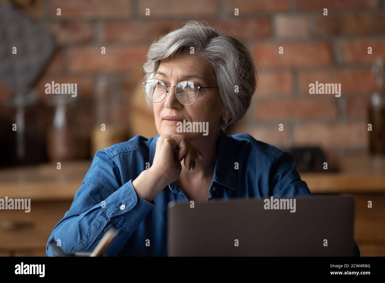 Pensive mature 60s woman look in distance thinking Stock Photo - Alamy