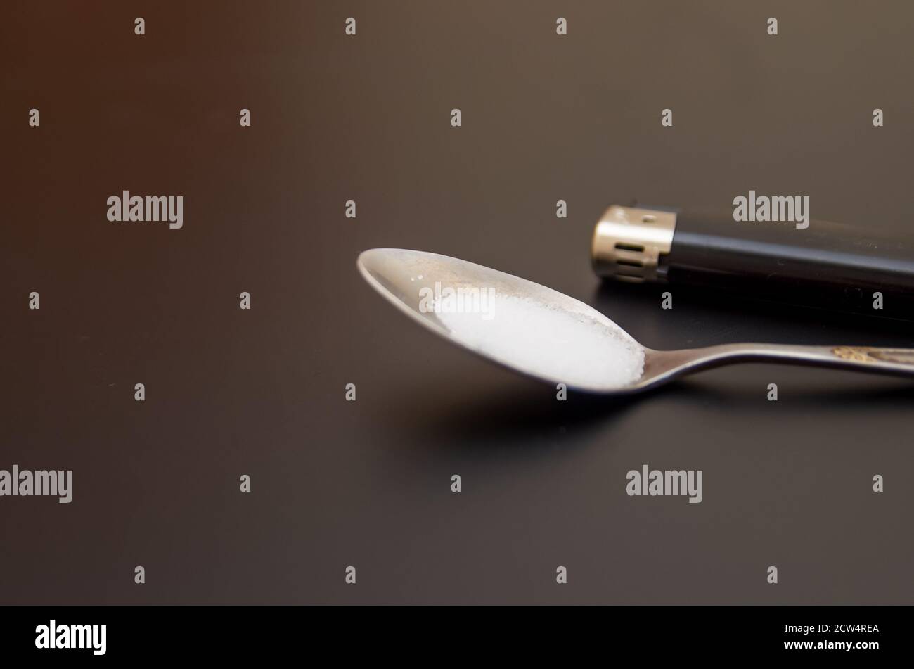 spoon with drugs for heroin cooking on dark table. Drug addiction ...