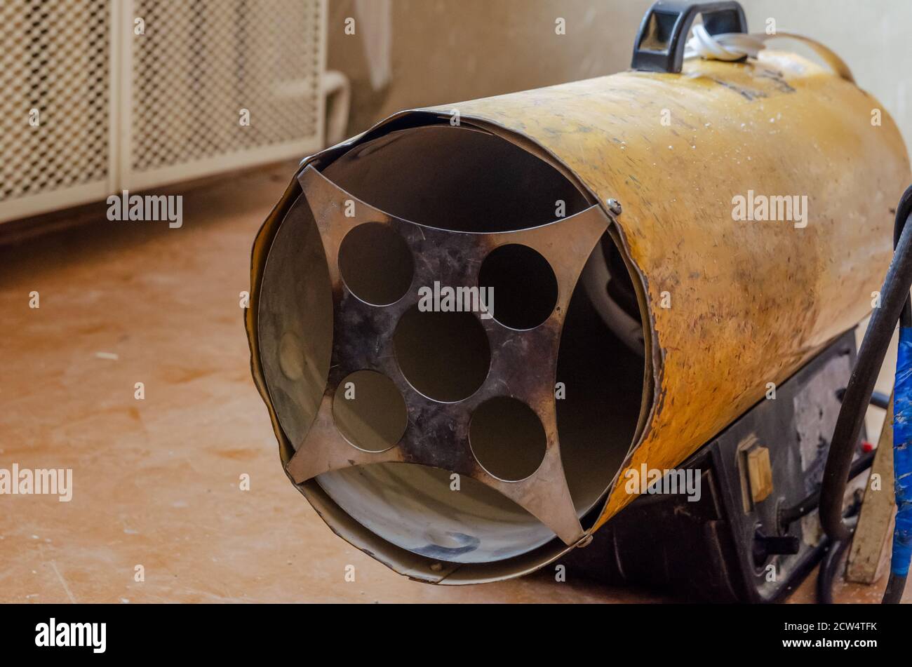 Gas heat gun. The repairman installs a stretch ceiling made of PVC ...