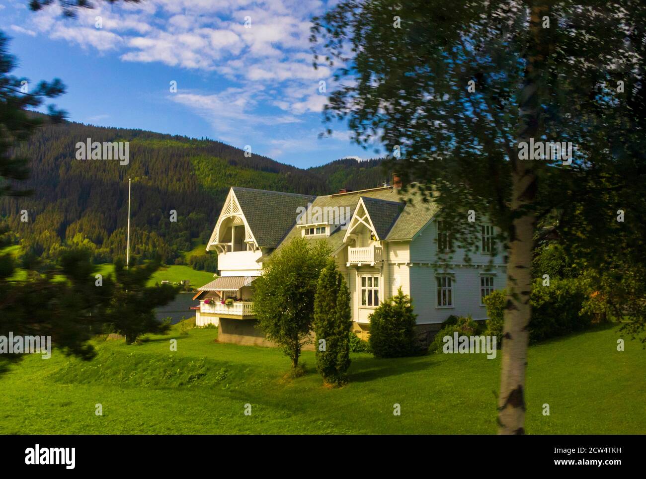 Traditional Scandinavian house at summer scenery seen from E16-European ...