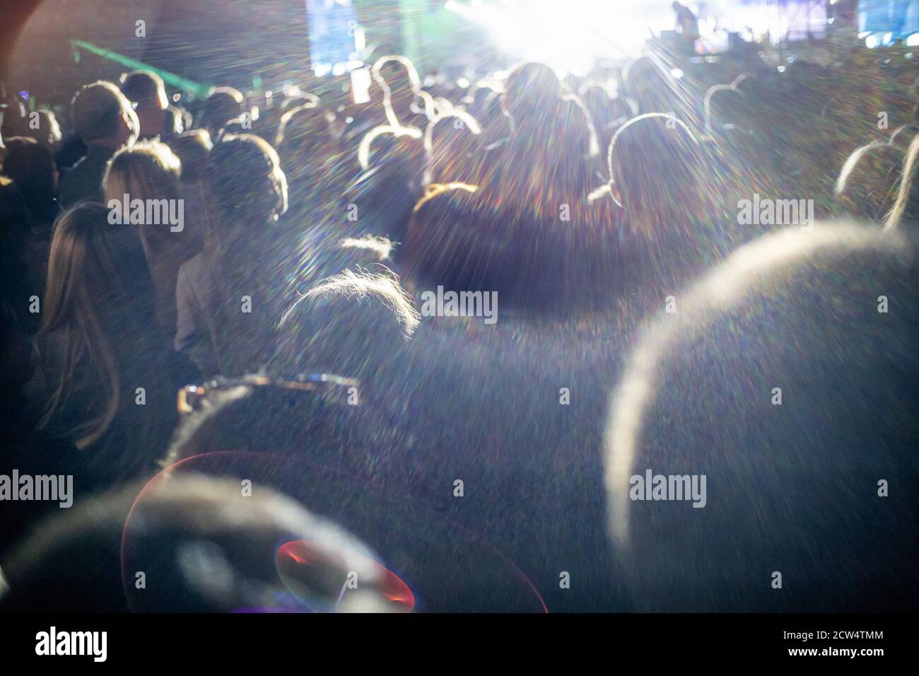 crowd of people during the concert. Dark background, smoke, concert ...