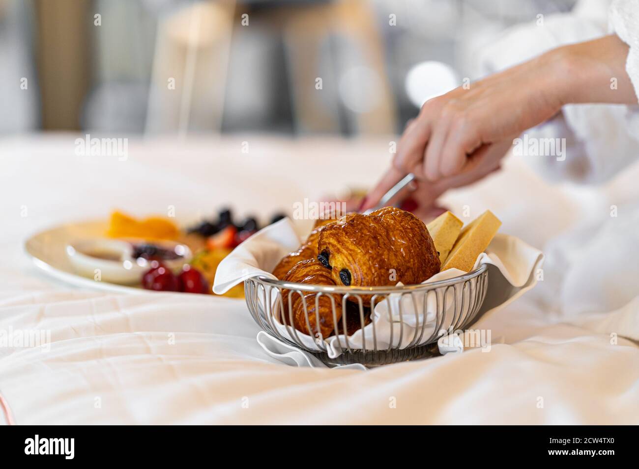 Woman eating breakfast in bed hi-res stock photography and images - Alamy