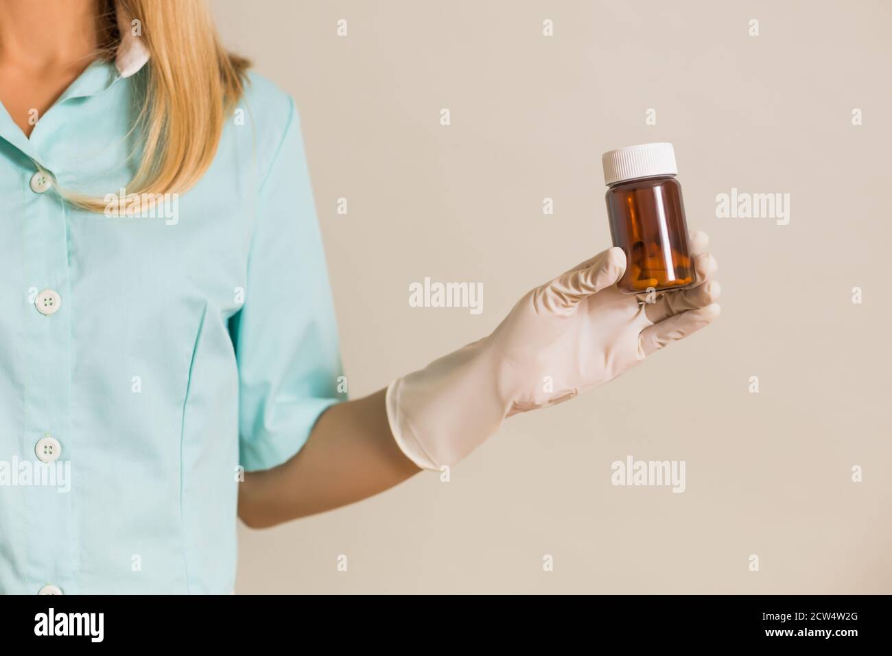 Doctor nurse giving pill bottle hi-res stock photography and images - Alamy