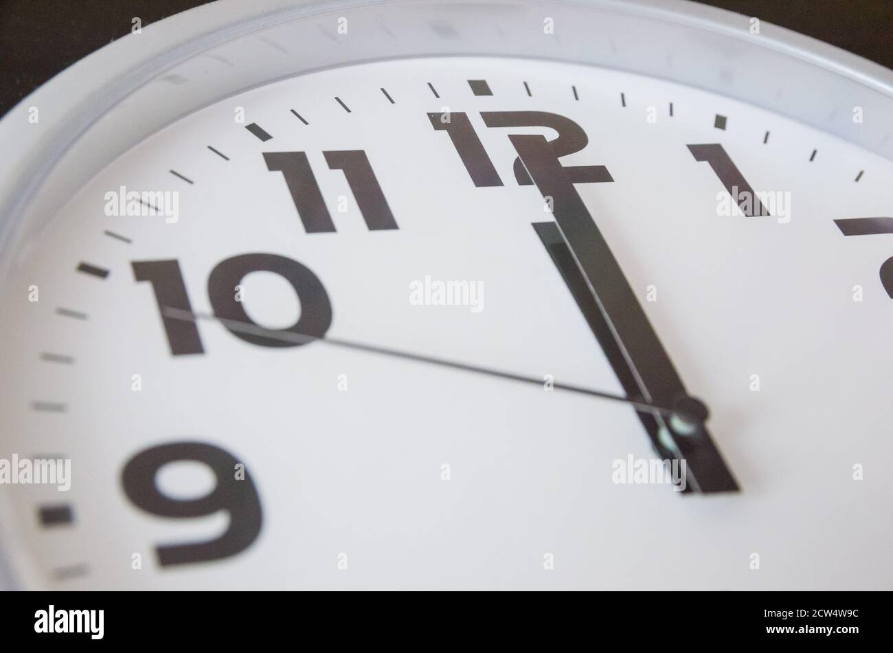 Macro photo of a black and white clock from 12 o'clock. Time concept ...