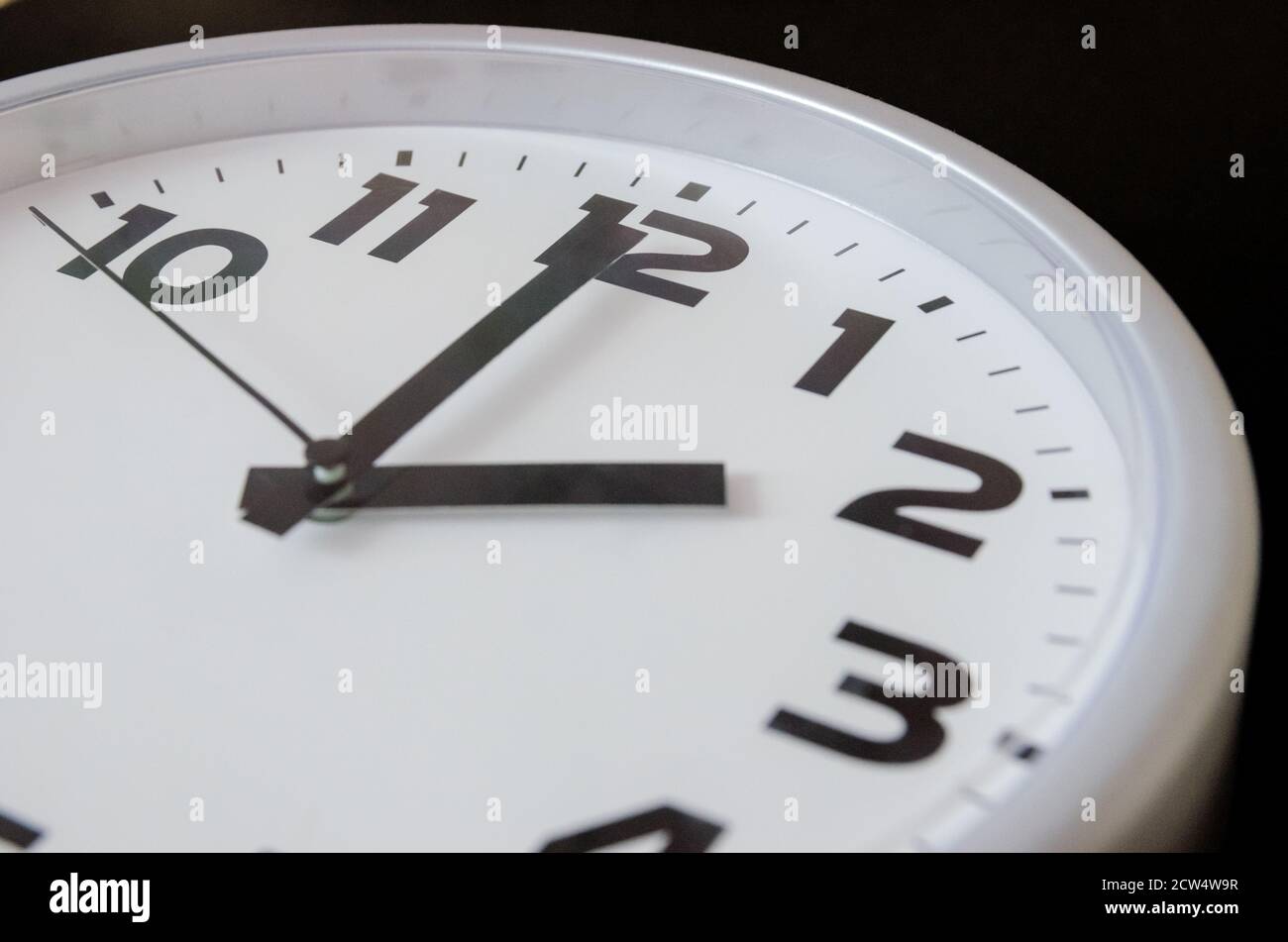 Close up of black and white analog clock with selective focus at 2 ...