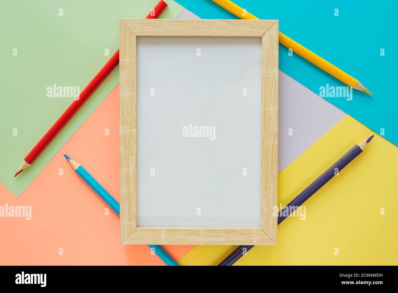 Creative flat lay with school suppllies. Mock up frame and multicolored ...