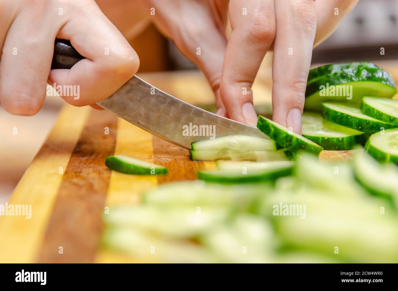 Man cutting cucumbers cook hi-res stock photography and images - Alamy