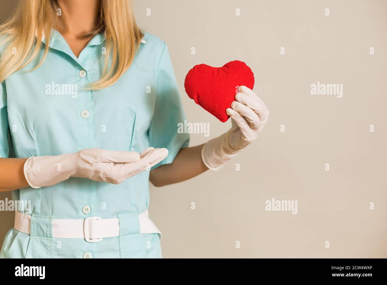 Image of medical nurse holding red heart Stock Photo - Alamy