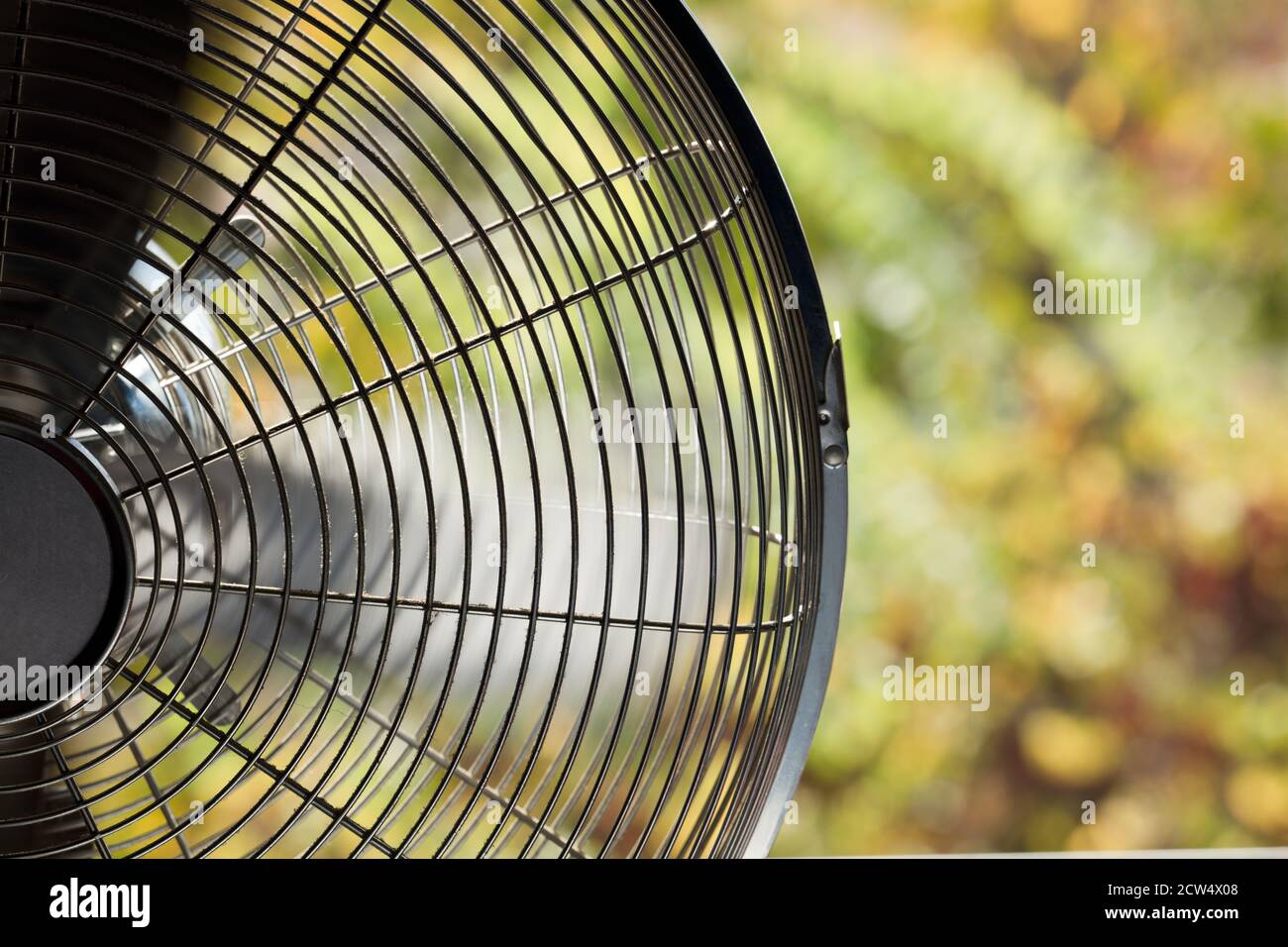 retro metal fan, with green trees background Stock Photo - Alamy