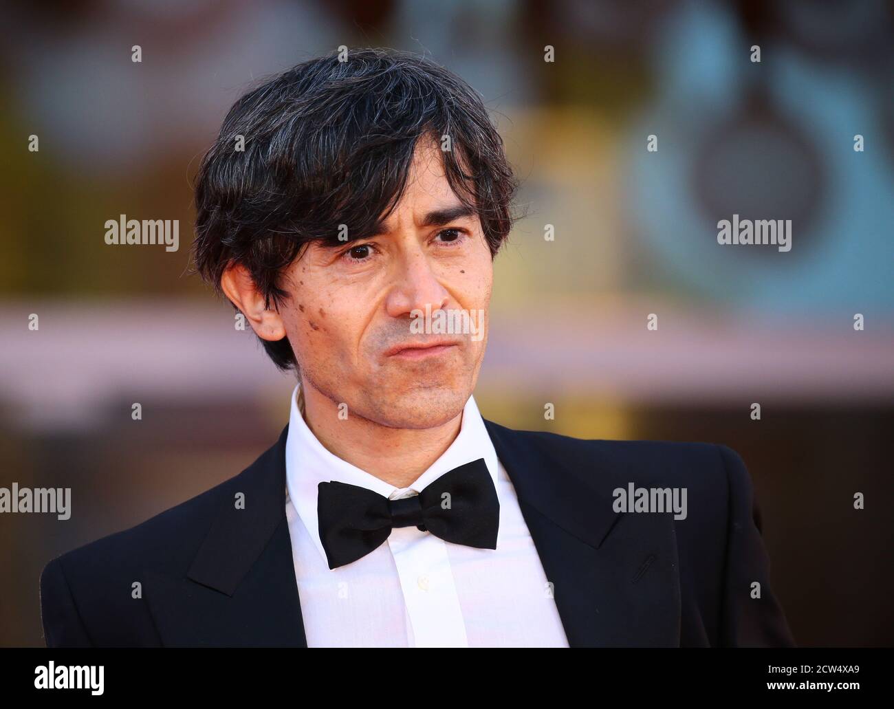 Luigi Lo Cascio poses on the red carpet during the 77th Venice Film ...