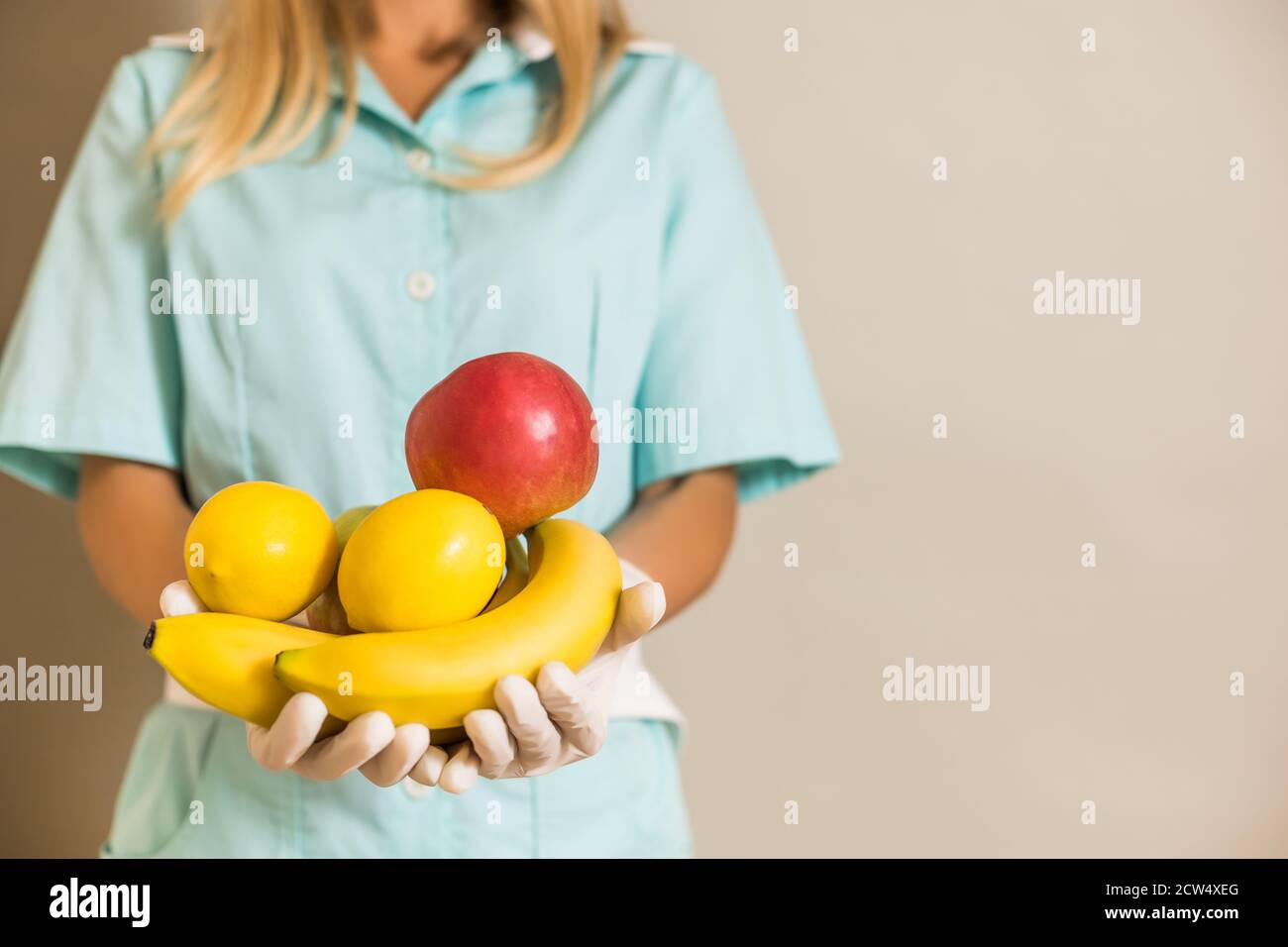 Image of medical nurse holding fruit Stock Photo - Alamy