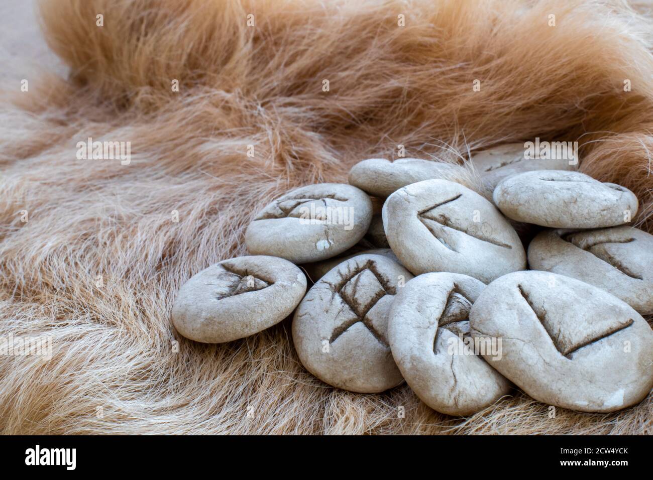 Stone runes on a fur. Futhark viking alphabet. Close up photo of Norse ...