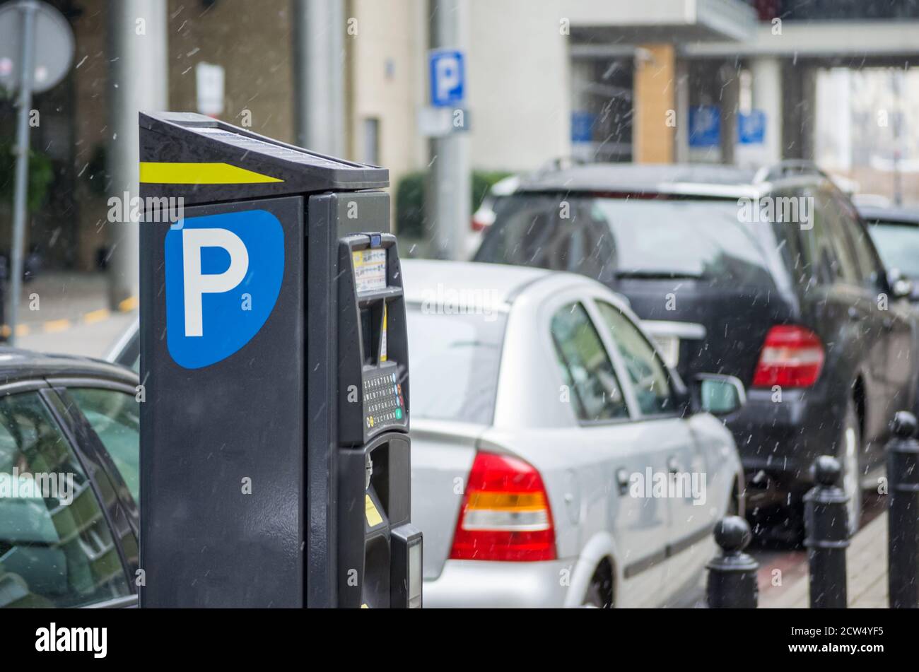 Parking meter machine on the street. Ticket pay station with cars on ...