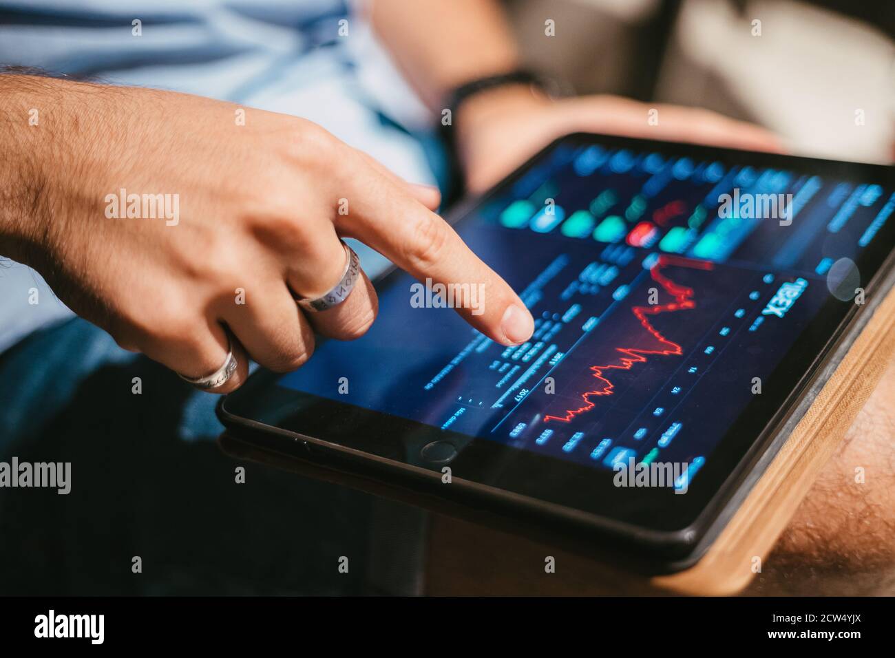 Man checking stock market data on tablet Stock Photo - Alamy