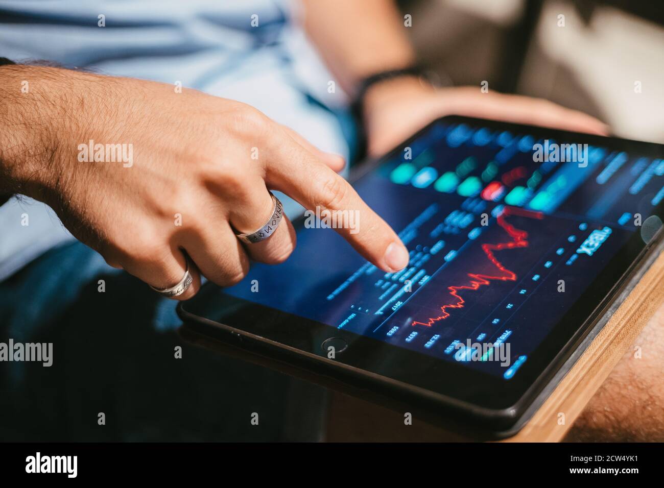 Man checking stock market data on tablet Stock Photo - Alamy