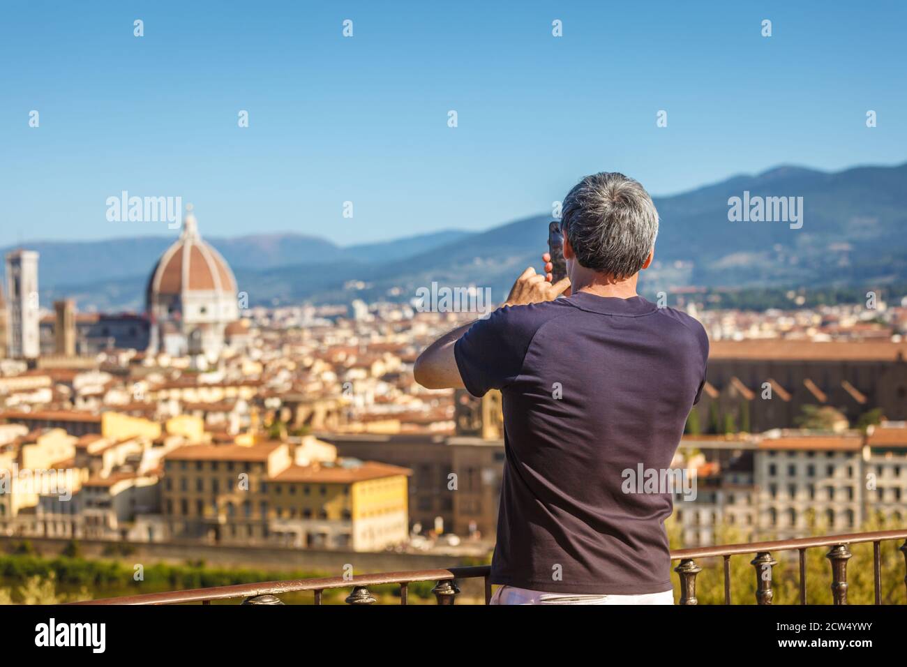 Candid authentic shot of caucasian mature man taking a shot of Florence ...