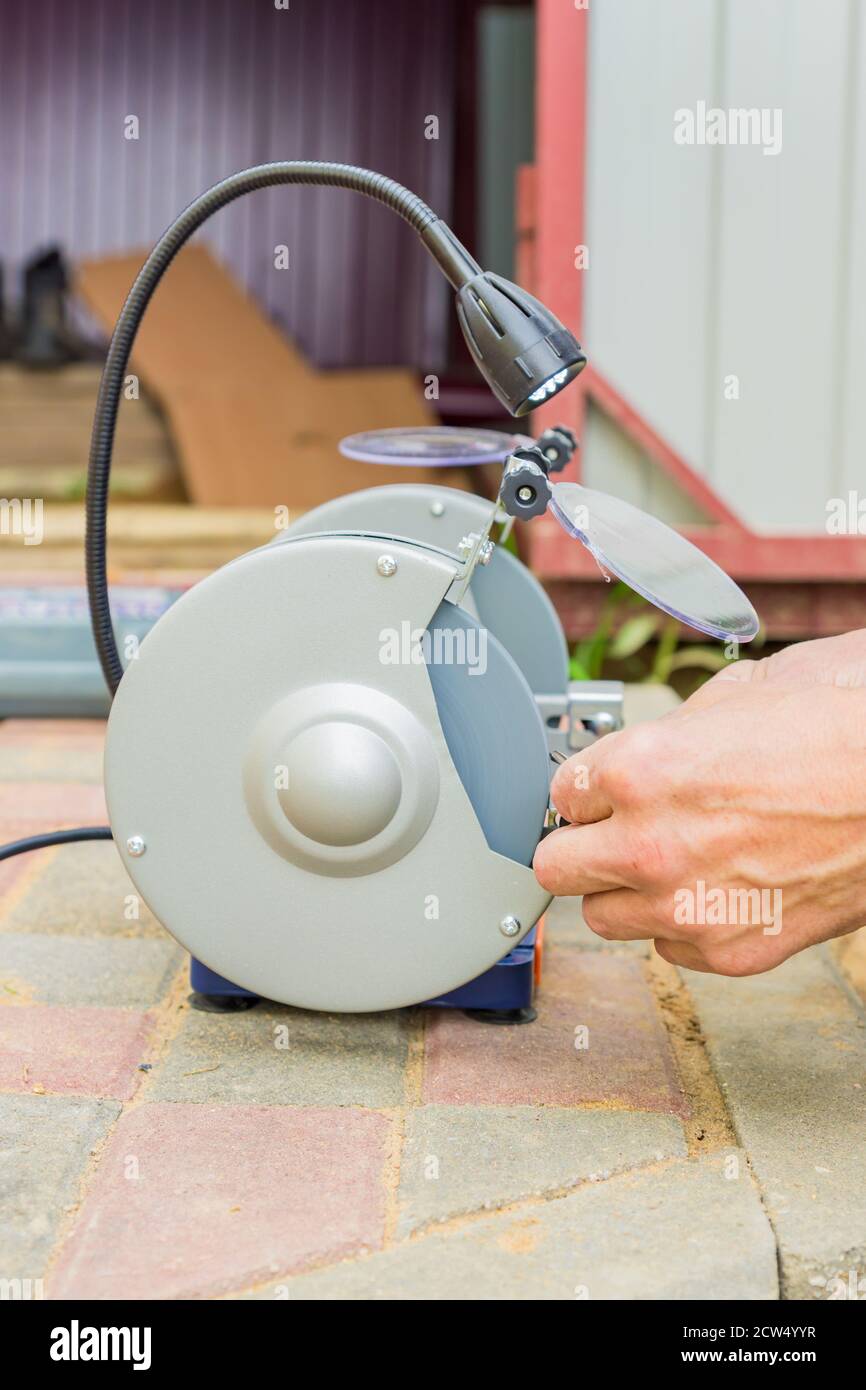 Industrial worker sharpening drill with grindstone abrasive disc cutter ...