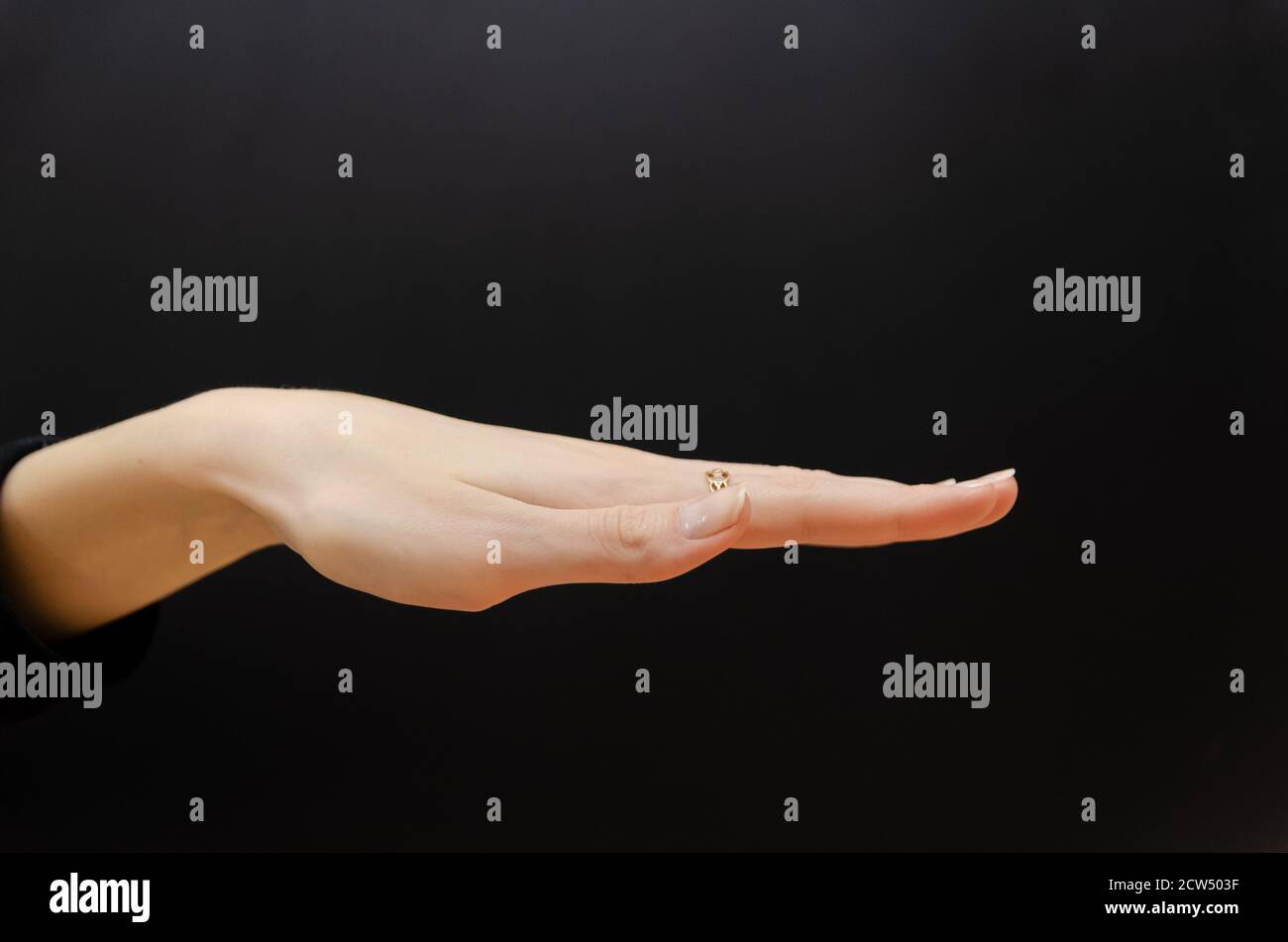 inverted female palm on a black background Stock Photo - Alamy